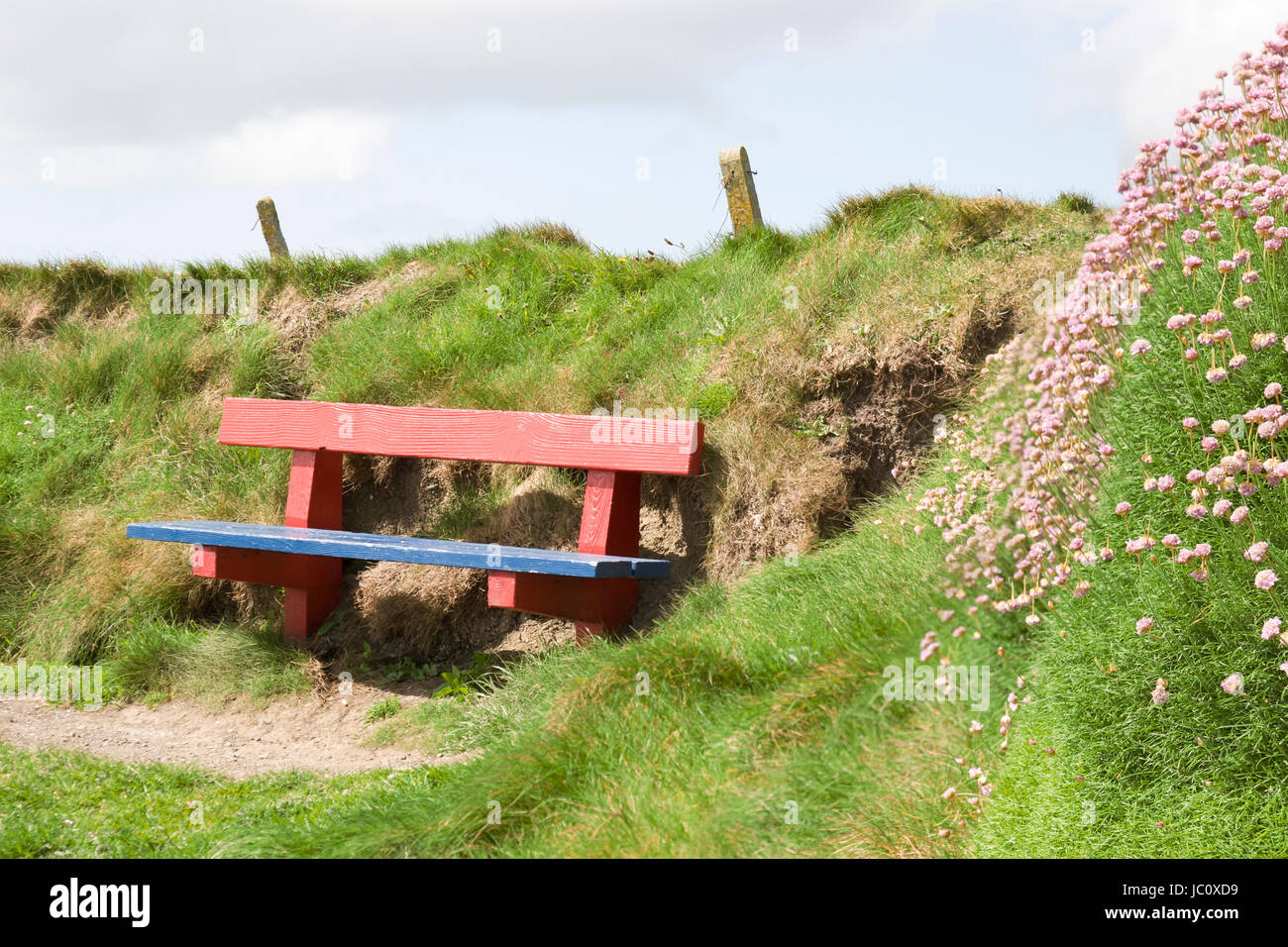 red and blue bench positioned at the edge on top of a cliff Stock Photo ...