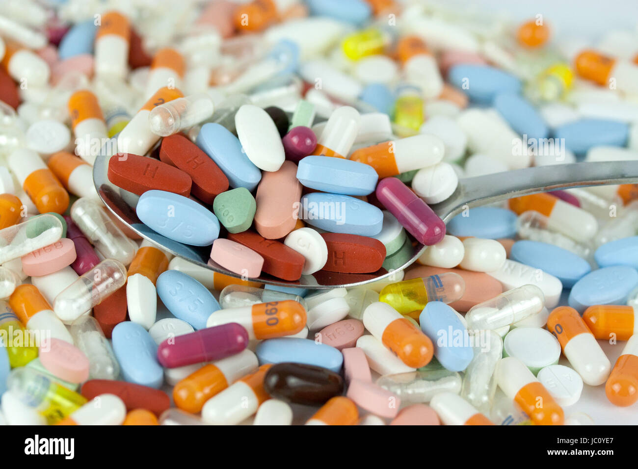 spoon on tablets Stock Photo - Alamy