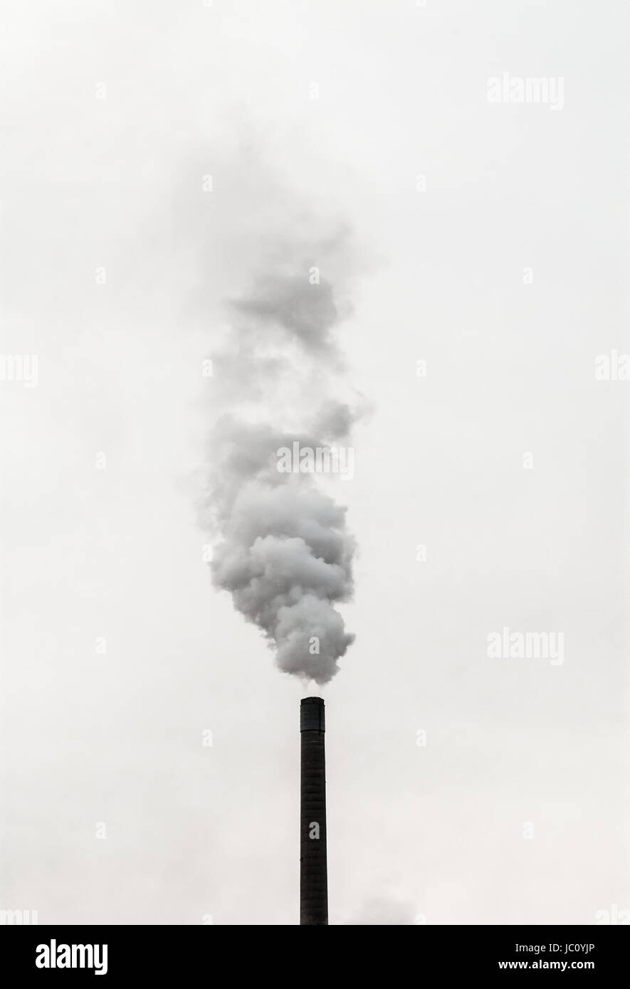Dark smoke stack billowing smoke into air on overcast sky Stock Photo ...