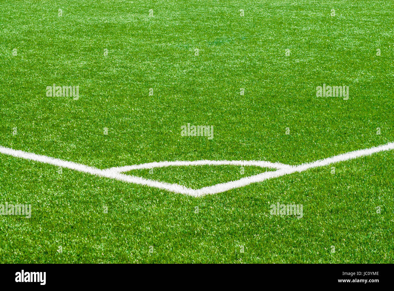 White corner line marker on green sports turf field Stock Photo - Alamy