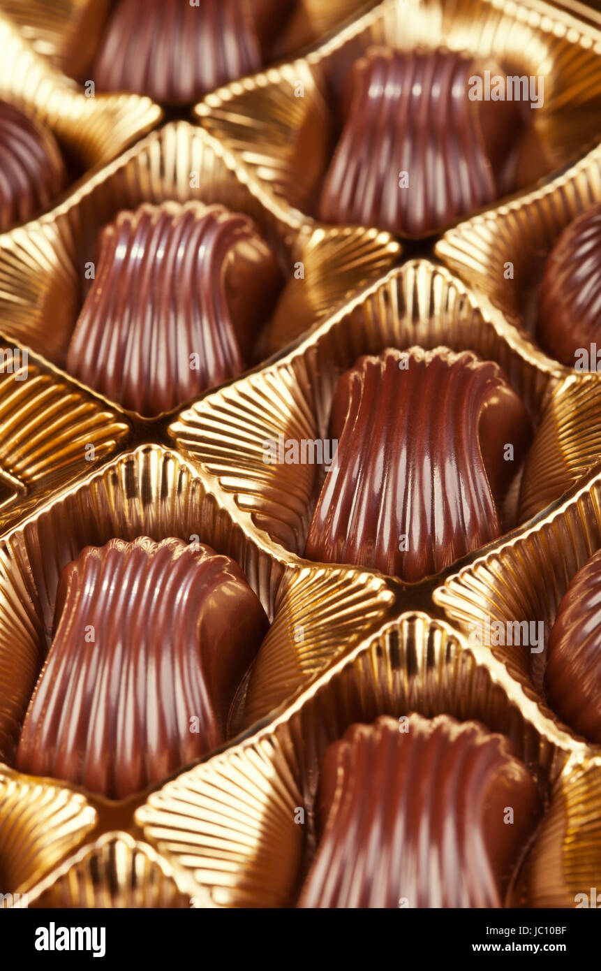Delicious chocolate pralines in the golden box Stock Photo - Alamy