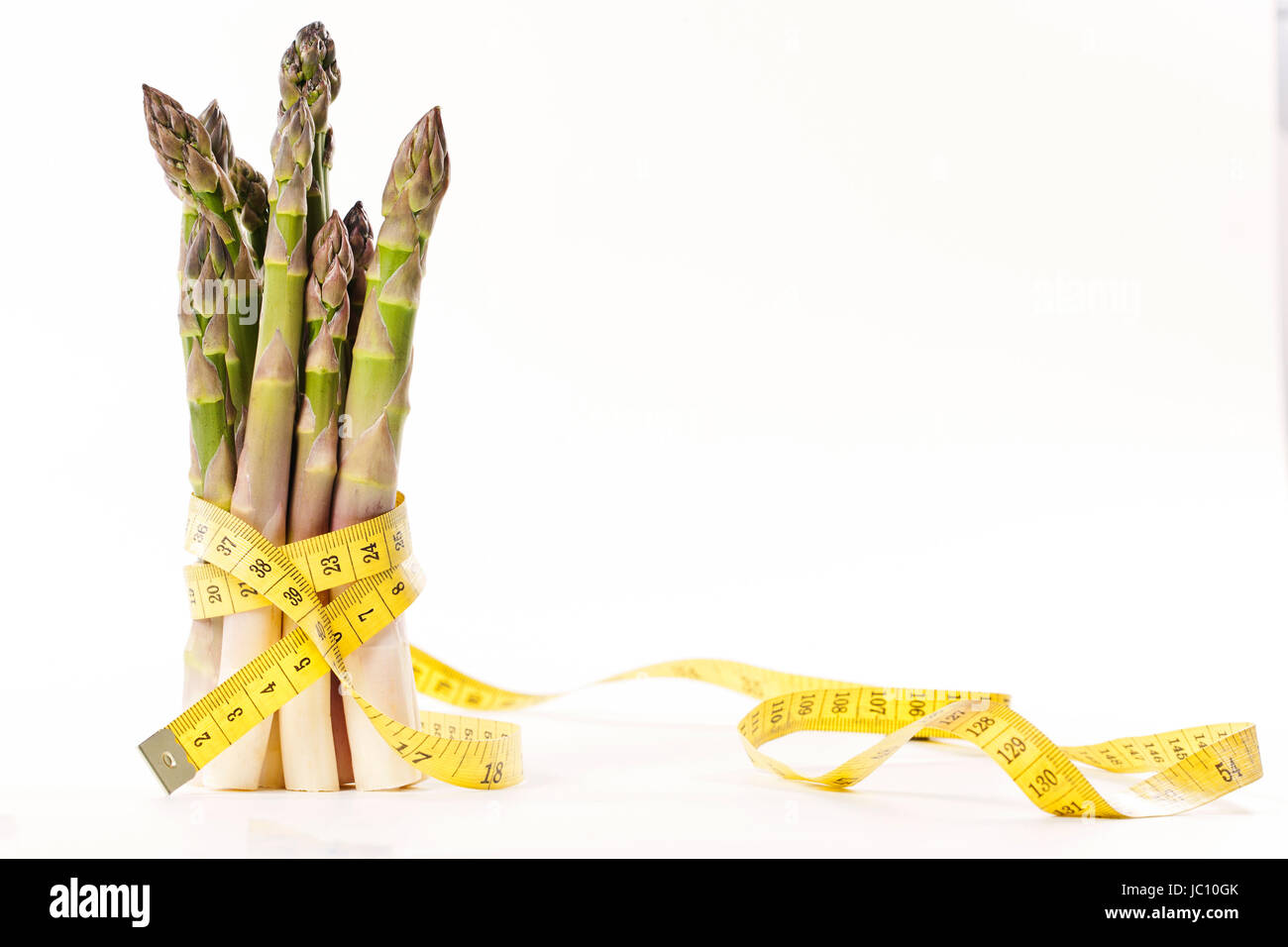 Asparagus and measuring type on a white background Stock Photo - Alamy