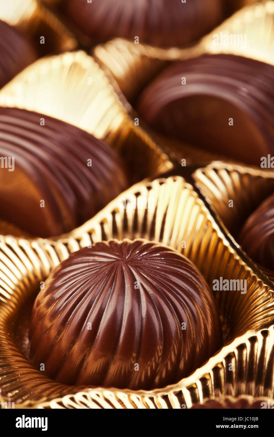 Delicious chocolate pralines in the golden box Stock Photo - Alamy