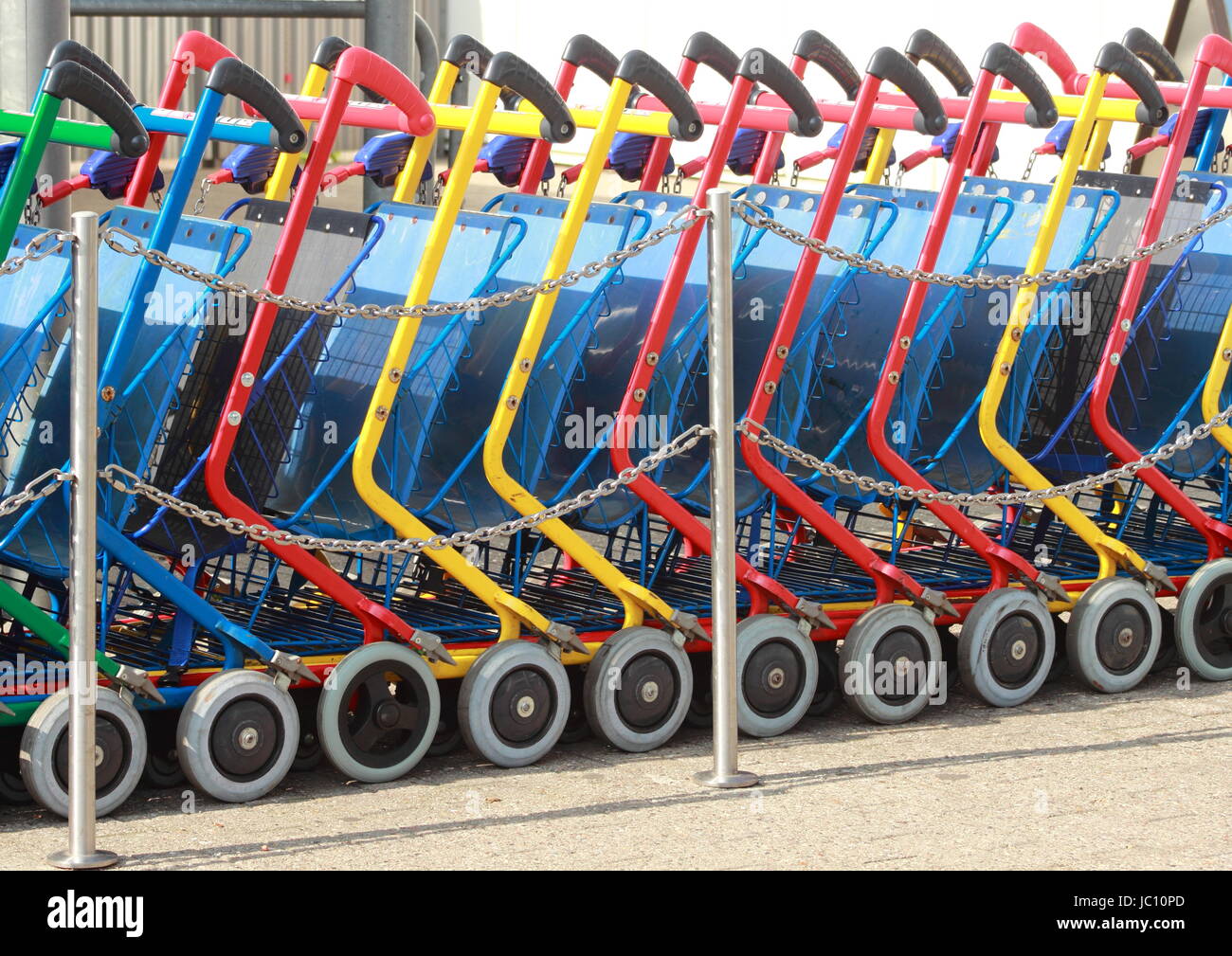 A line of colorful shopping carts in daylight Stock Photo - Alamy