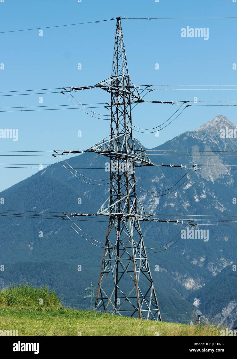 Pylon on mountain top with blue sky Stock Photo - Alamy