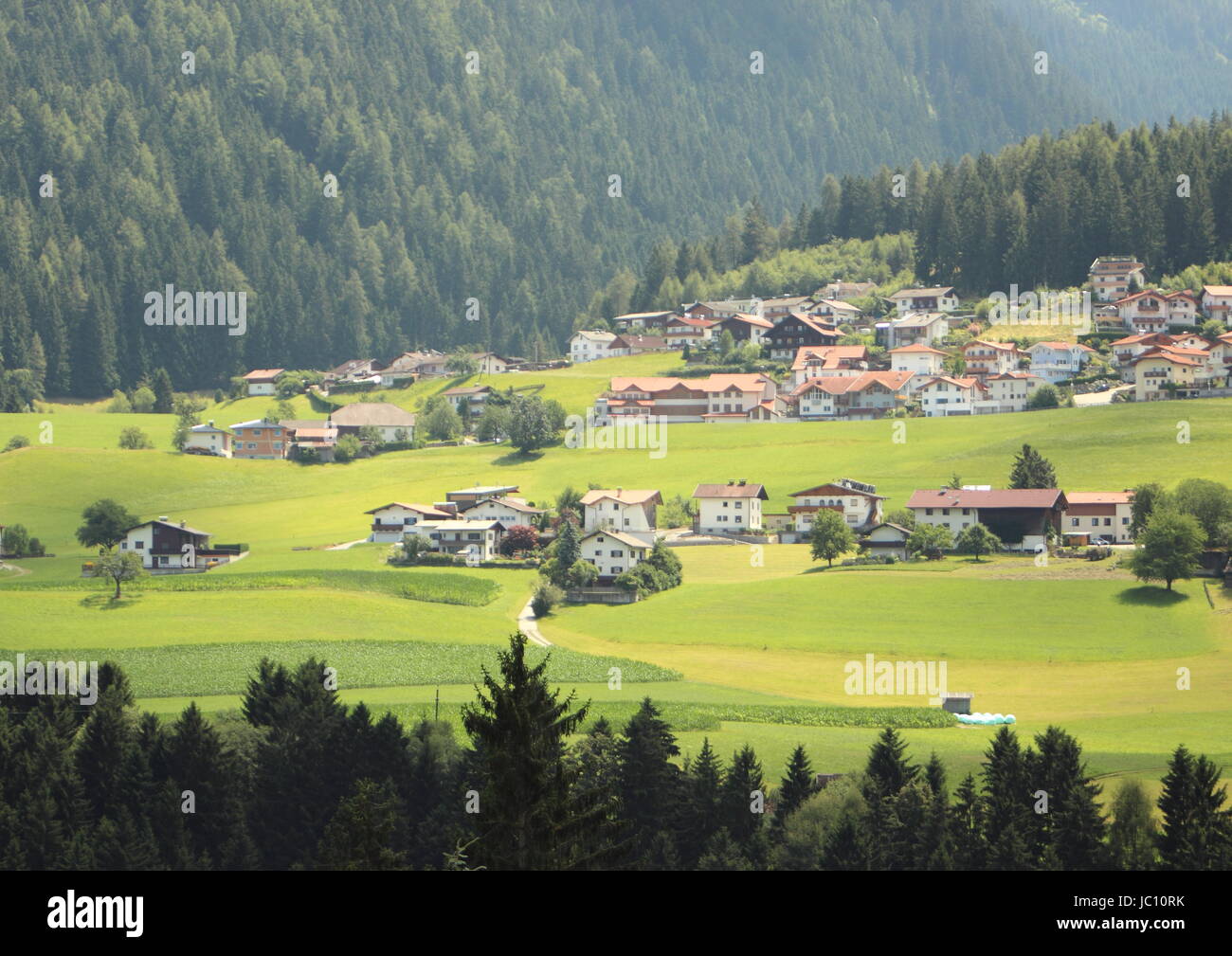 Valley in the Alps with small village Stock Photo - Alamy