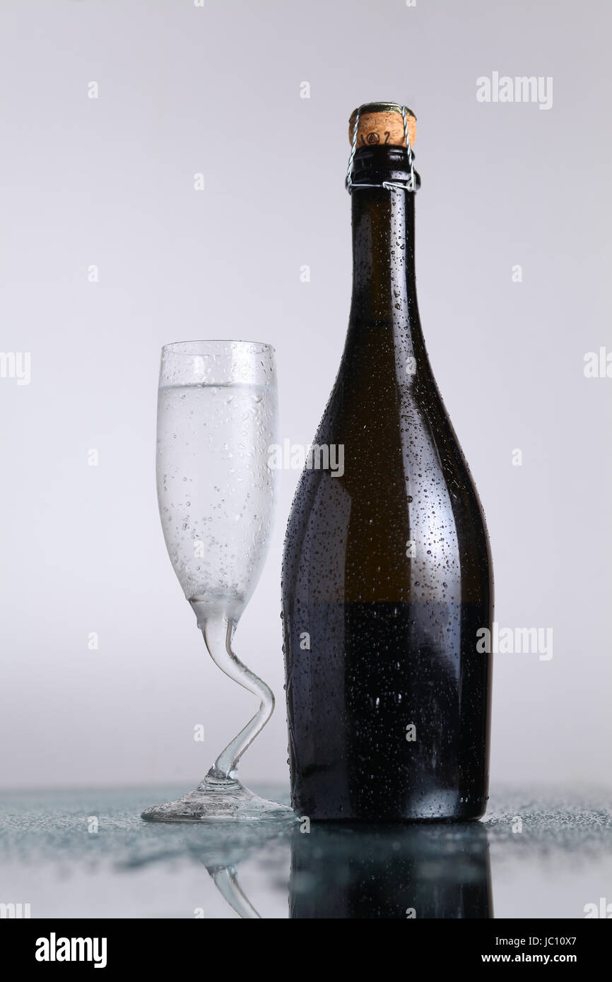 Champagne bottle with chilled class on a wet light surface Stock Photo ...