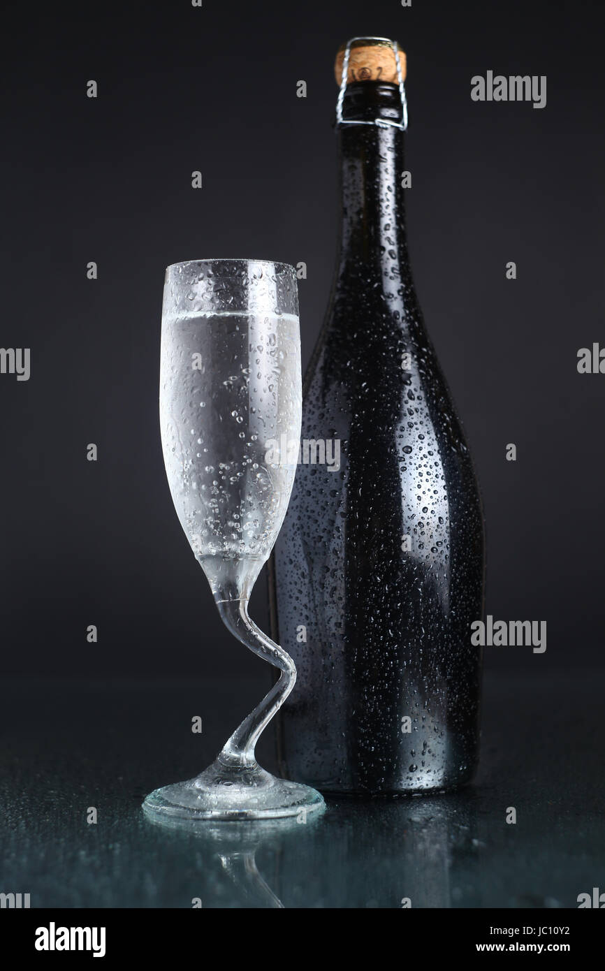 Champagne bottle with chilled class on a wet dark surface Stock Photo ...