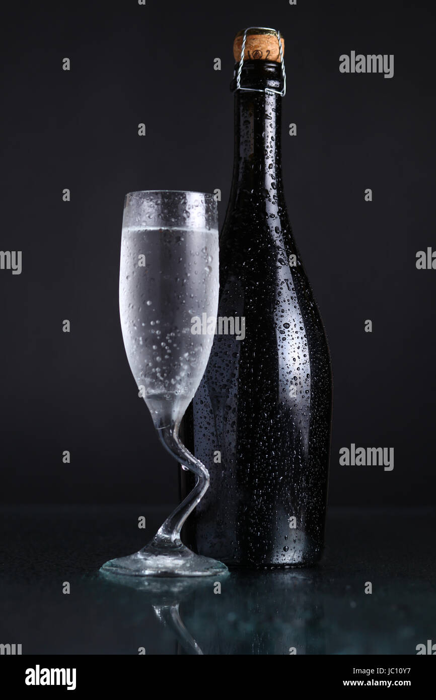 Champagne bottle with chilled class on a wet dark surface Stock Photo ...