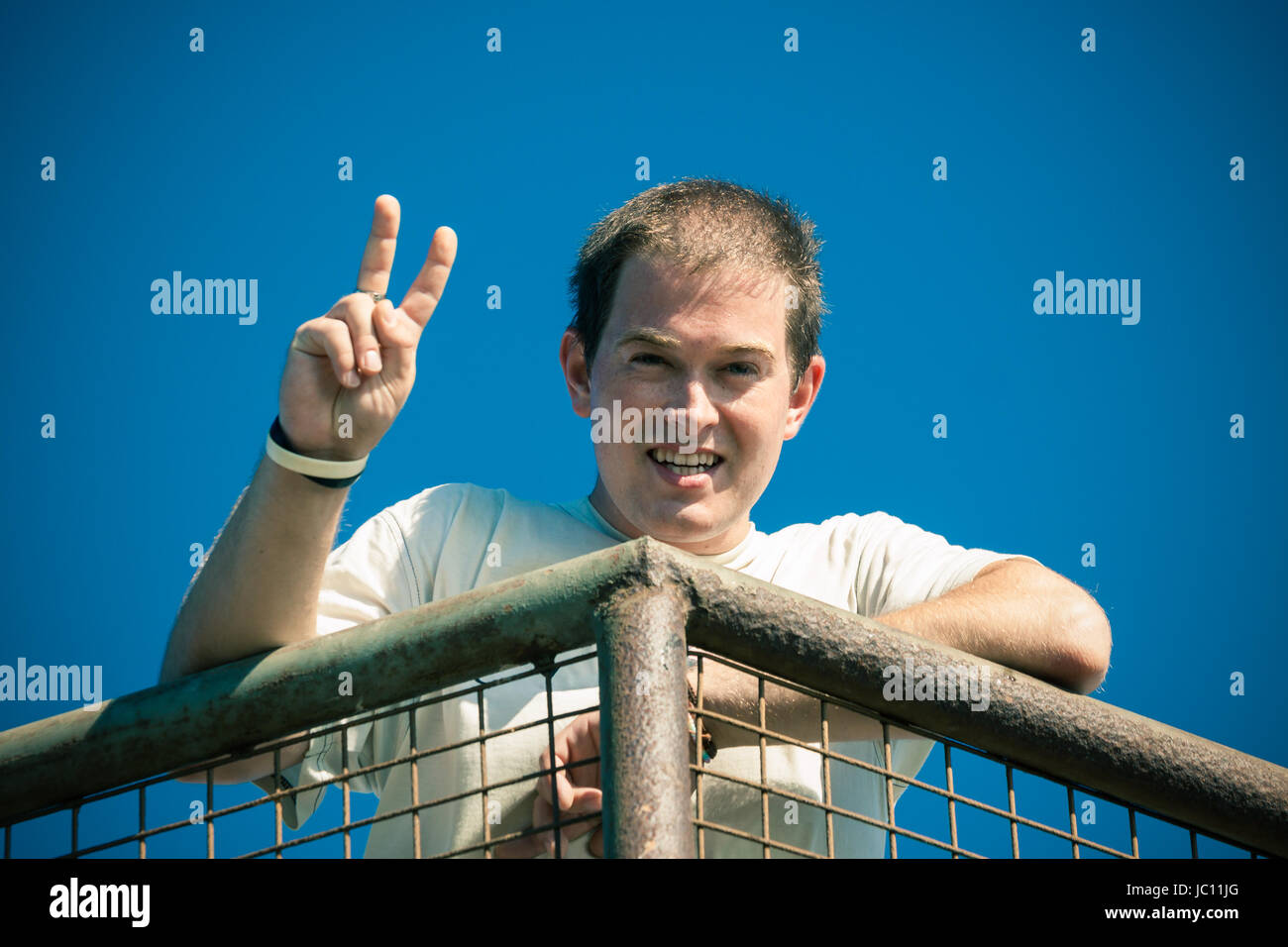 Outdoor portrait man victory sign hi-res stock photography and images ...