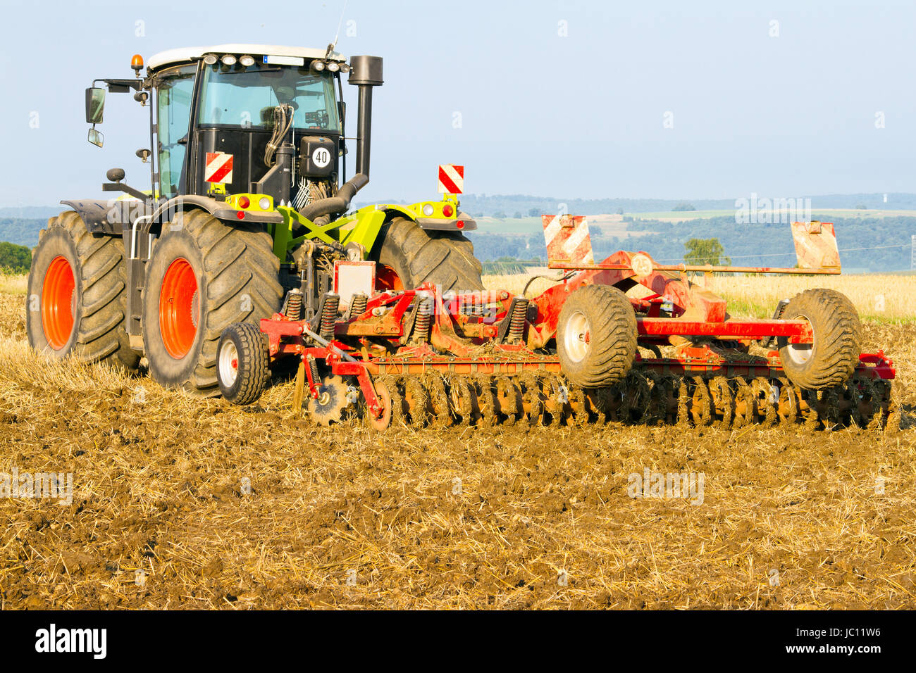 tractor works the soil Stock Photo - Alamy