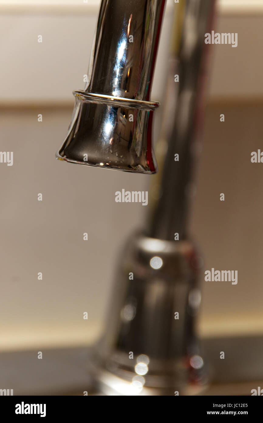 A chrome kitchen water faucet up close Stock Photo - Alamy