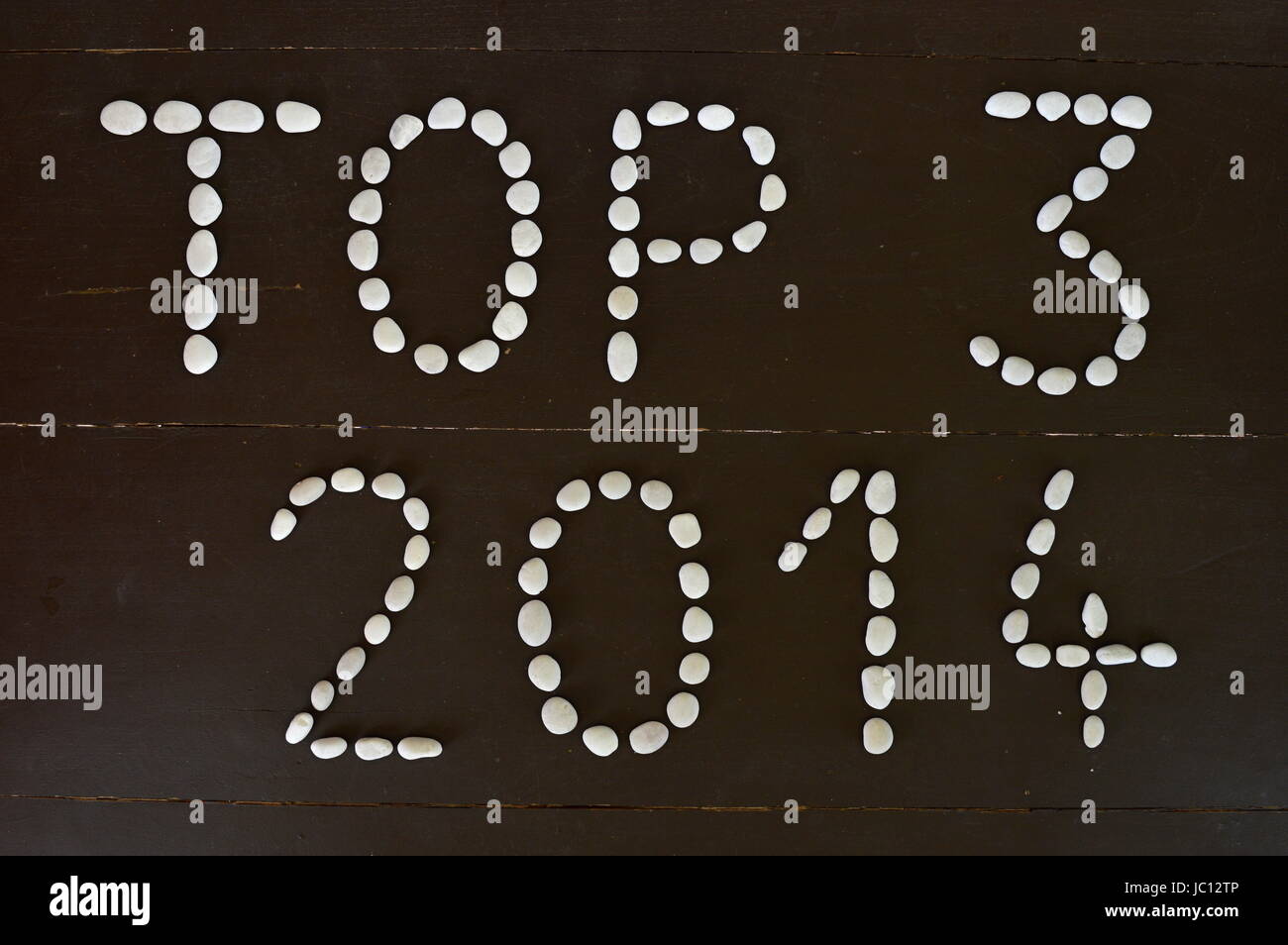 Writing with white pebble stones Stock Photo - Alamy