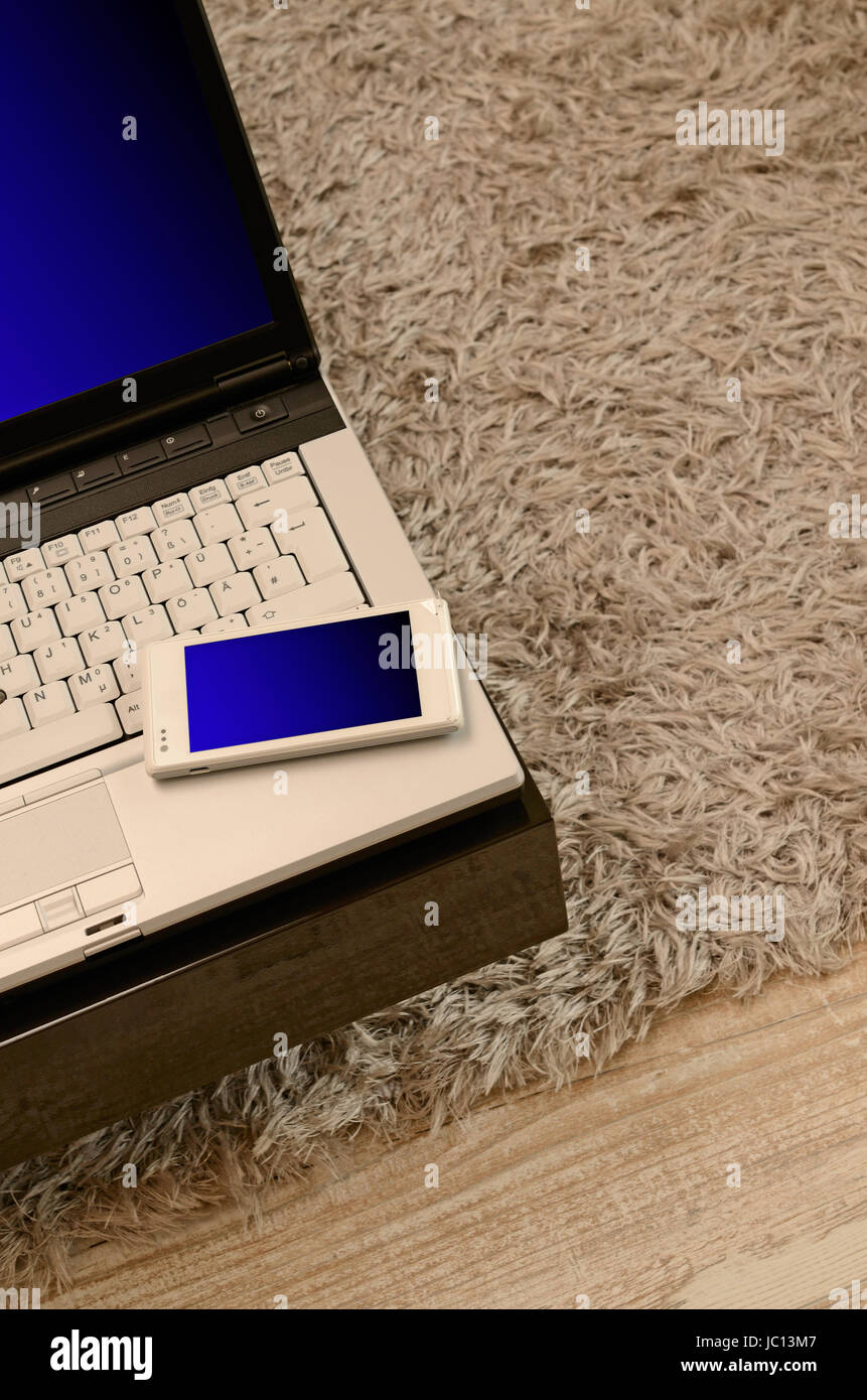 Notebook with a cellphone on a modern table in a living room Stock ...