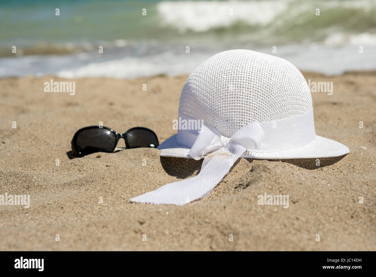 White wicker hat and black sunglasses on the beach Stock Photo - Alamy