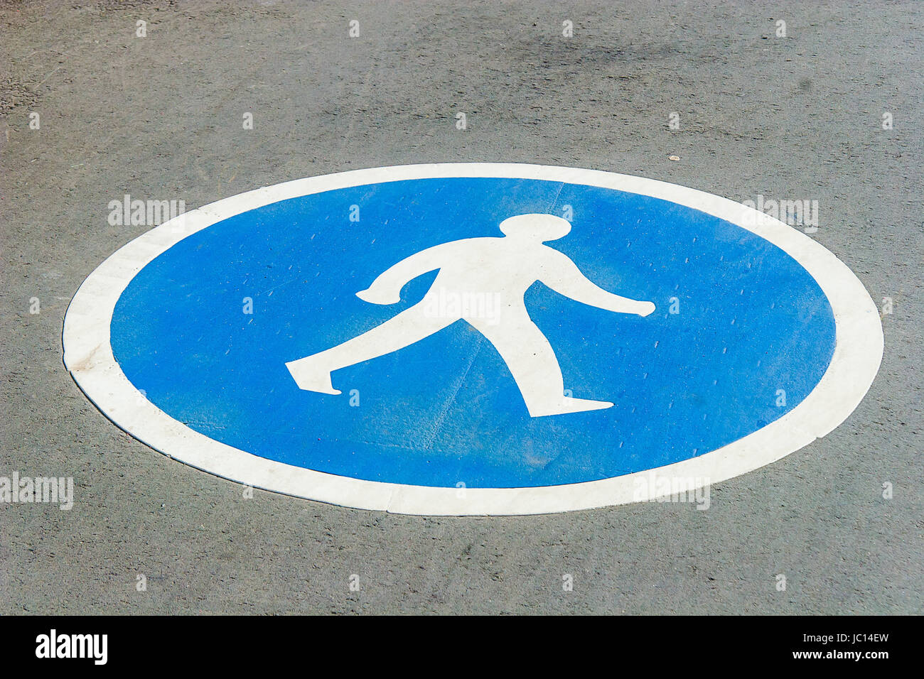 Pedestrian lane blue sign on asphalt road Stock Photo - Alamy