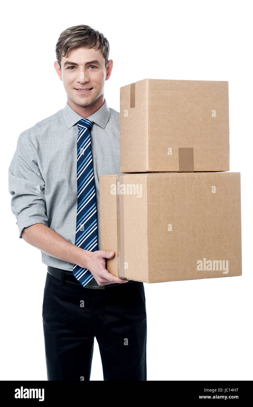 Smiling corporate man holding stack of boxes Stock Photo - Alamy