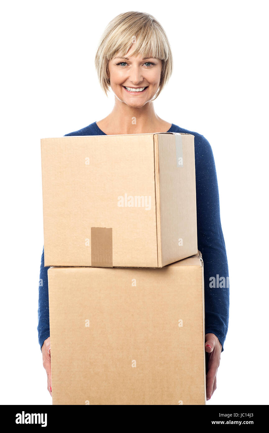 Attractive woman posing with stack of boxes Stock Photo - Alamy