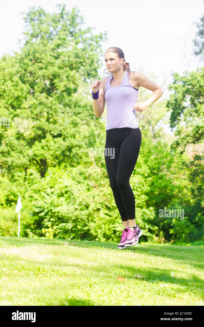 Fitness young woman jogging in the park.Running woman Stock Photo - Alamy