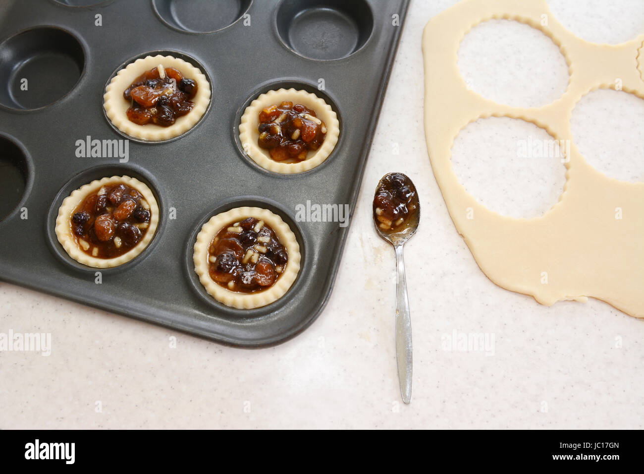 Making mince pies in the kitchen - filled pastry cases, mincemeat ...