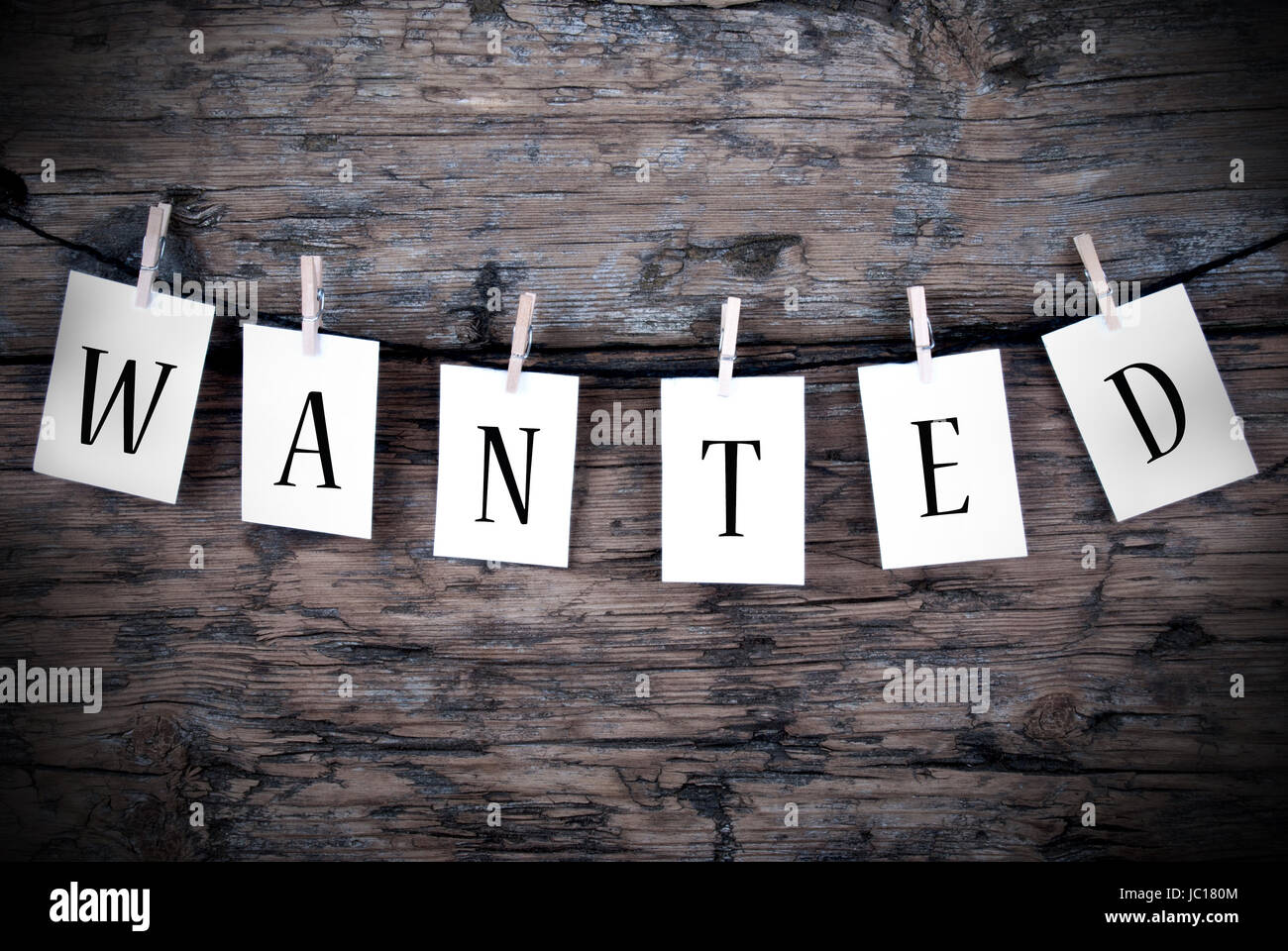 The Word Wanted on White Labels Hanging on a Line on Wooden Background ...