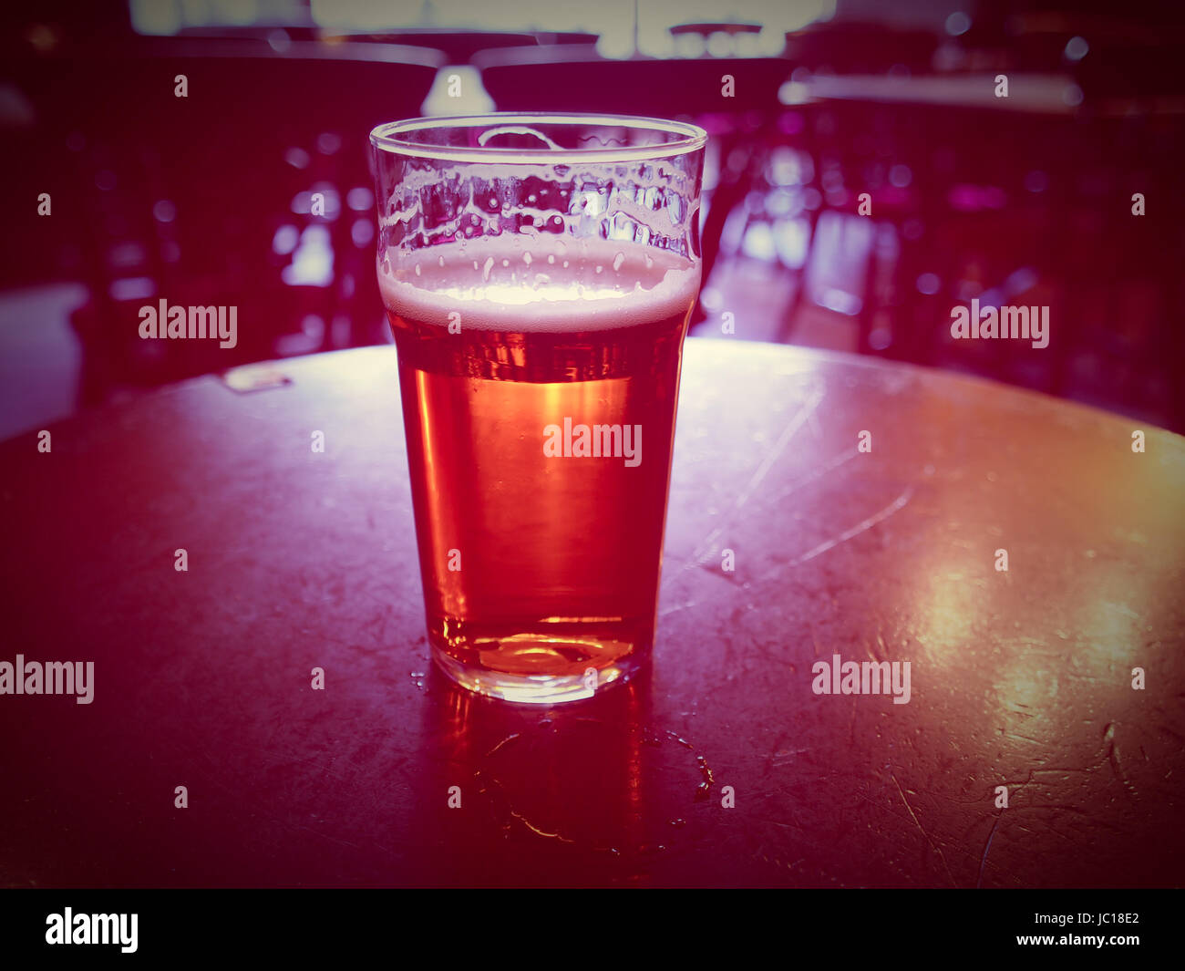 Vintage looking pint of English bitter ale in a pub Stock Photo - Alamy