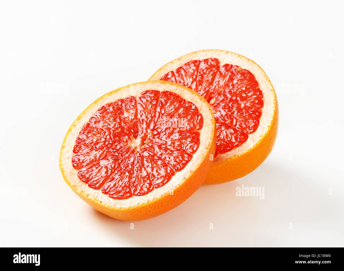 Two halves of red grapefruit Stock Photo - Alamy
