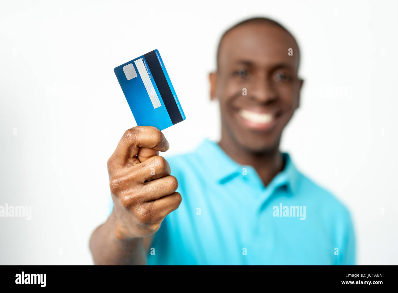 Handsome man showing his debit card to camera Stock Photo - Alamy
