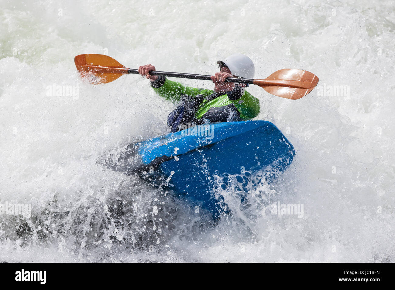 an active male kayaker rolling and surfing in rough water Stock Photo ...