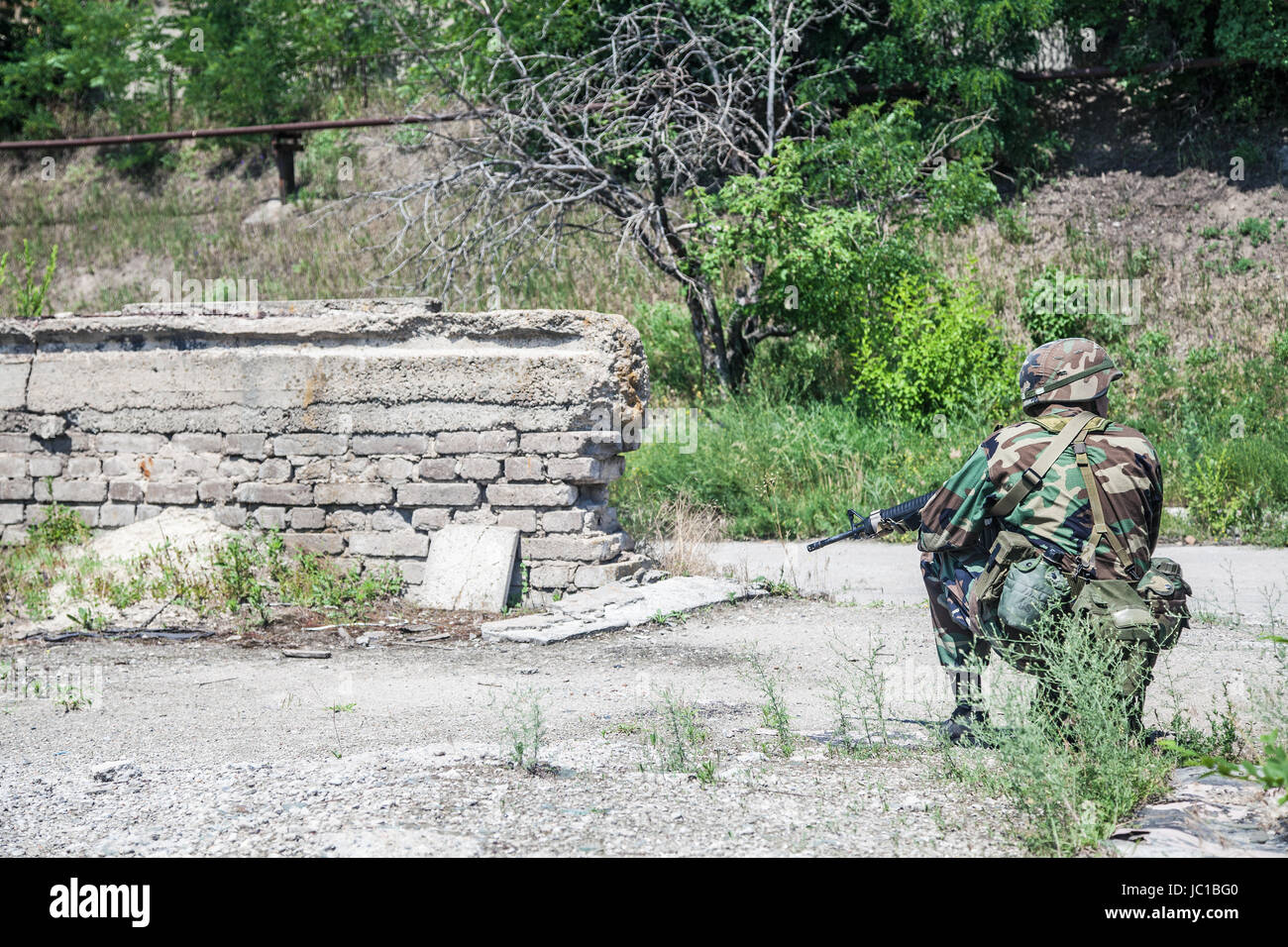 NATO soldier with machine gun during the military operation Stock Photo ...