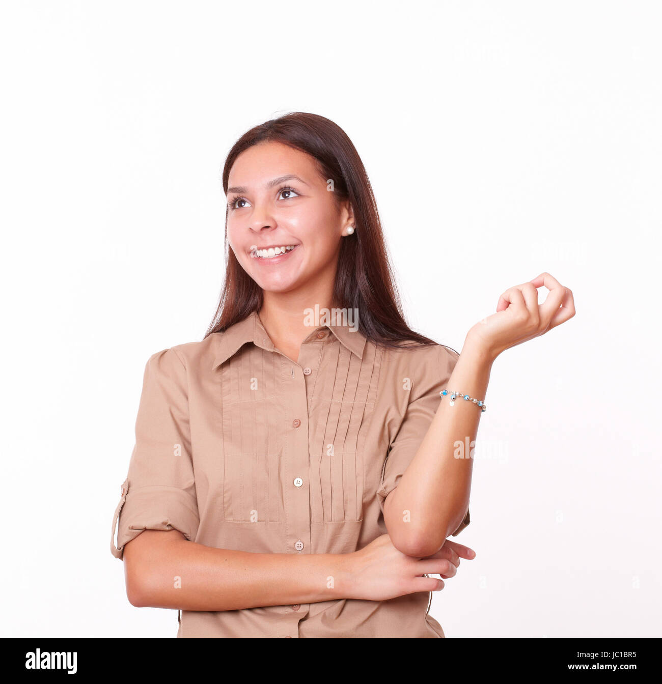 Portrait of young lovely girl on brown blouse looking to her right ...