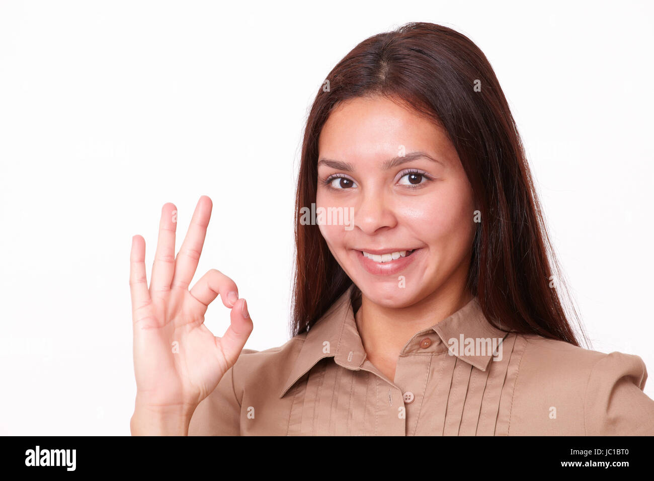 Closeup portrait of beautiful hispanic lady on brown blouse with ok ...