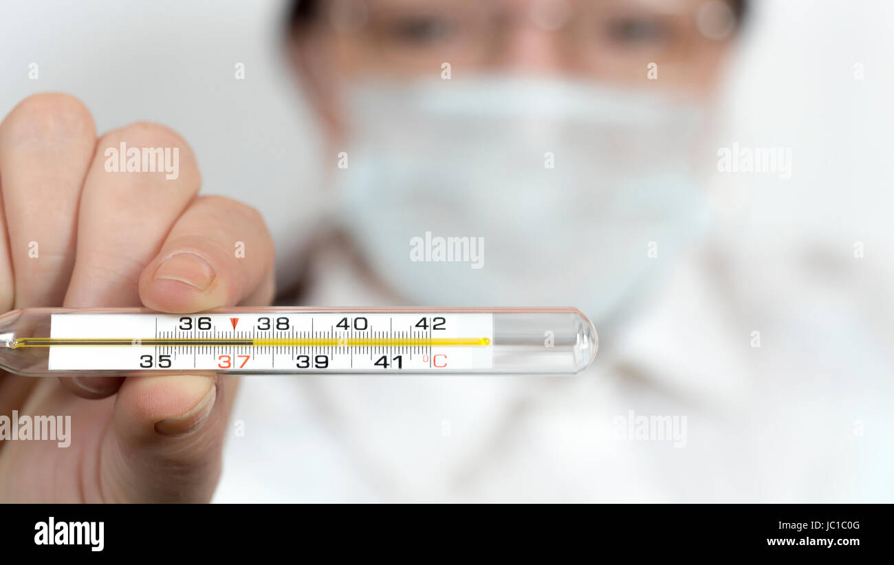 Doctor shows thermometer closeup Stock Photo - Alamy