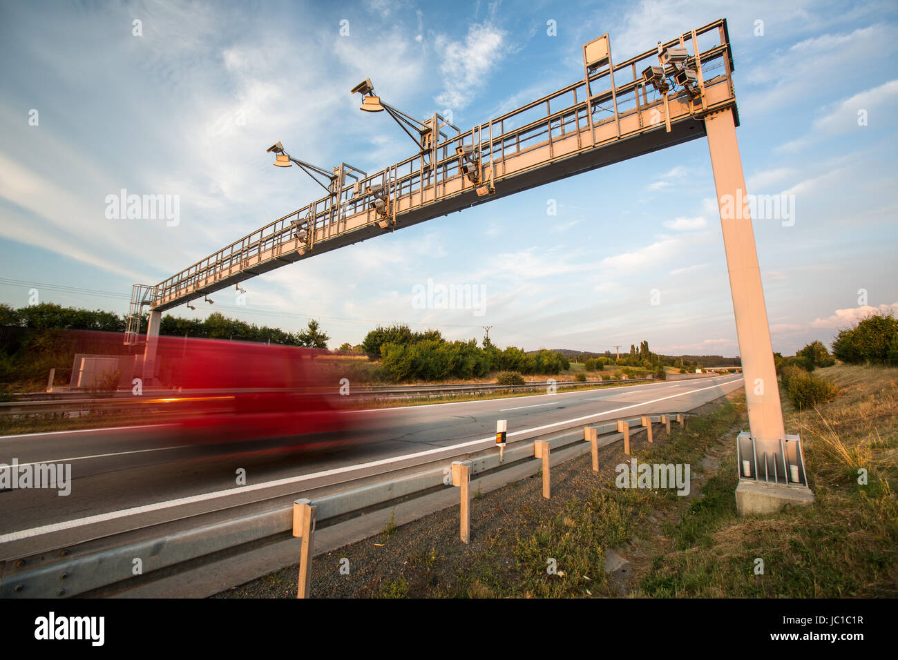 truck passing through a toll gate on a highway (motion blurred image ...