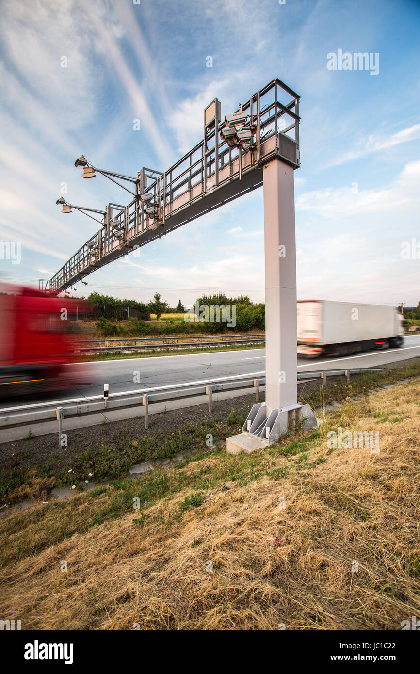 truck passing through a toll gate on a highway (motion blurred image ...