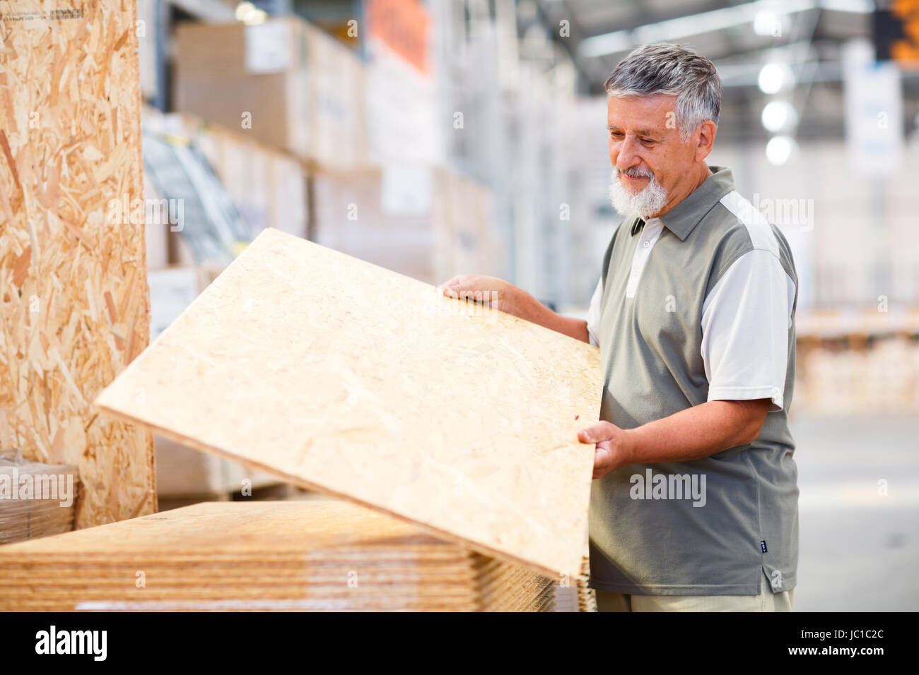 Man choosing and buying construction wood in a DIY store for his DIY ...