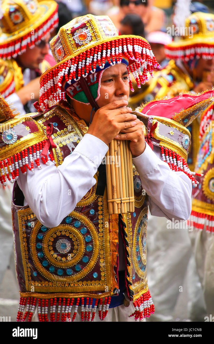 Local man playing flute during Festival of the Virgin de la Candelaria ...