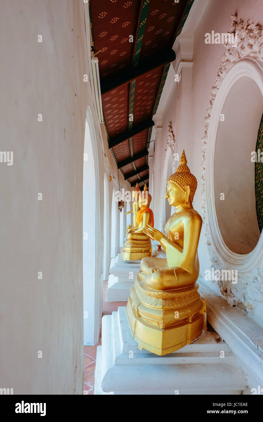golden buddhism monk statue in asian temple Stock Photo - Alamy