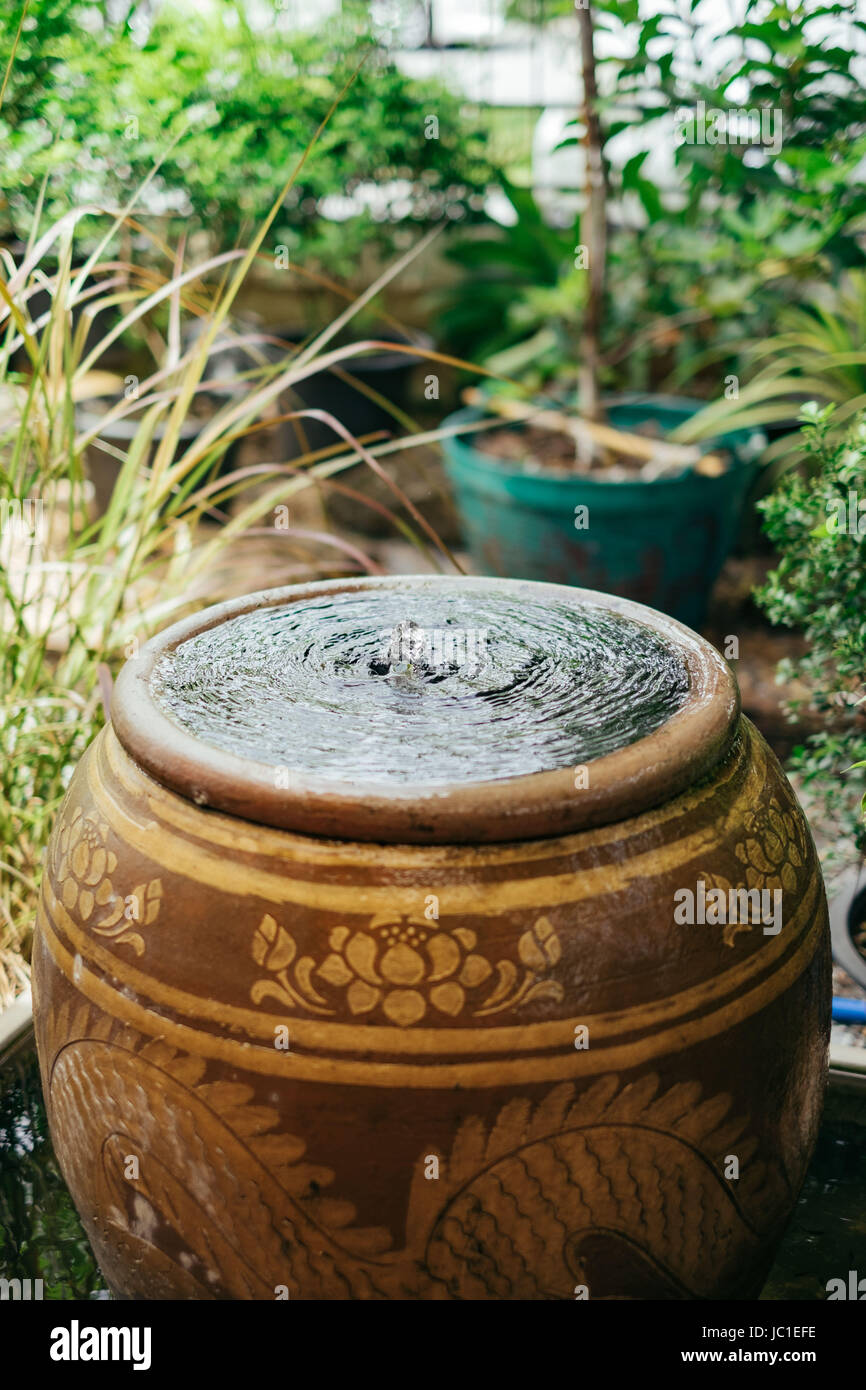 Big earthen jar full of water in the garden Stock Photo - Alamy