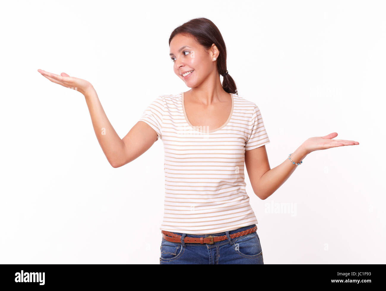 Portrait of attractive beautiful girl on blue jeans holding her palms ...