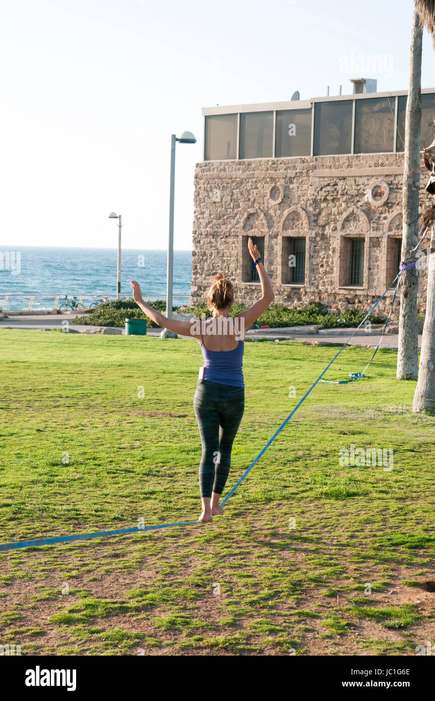 woman Slacklining in Charles Clore park, Tel Aviv-Jaffa with Elinor ...