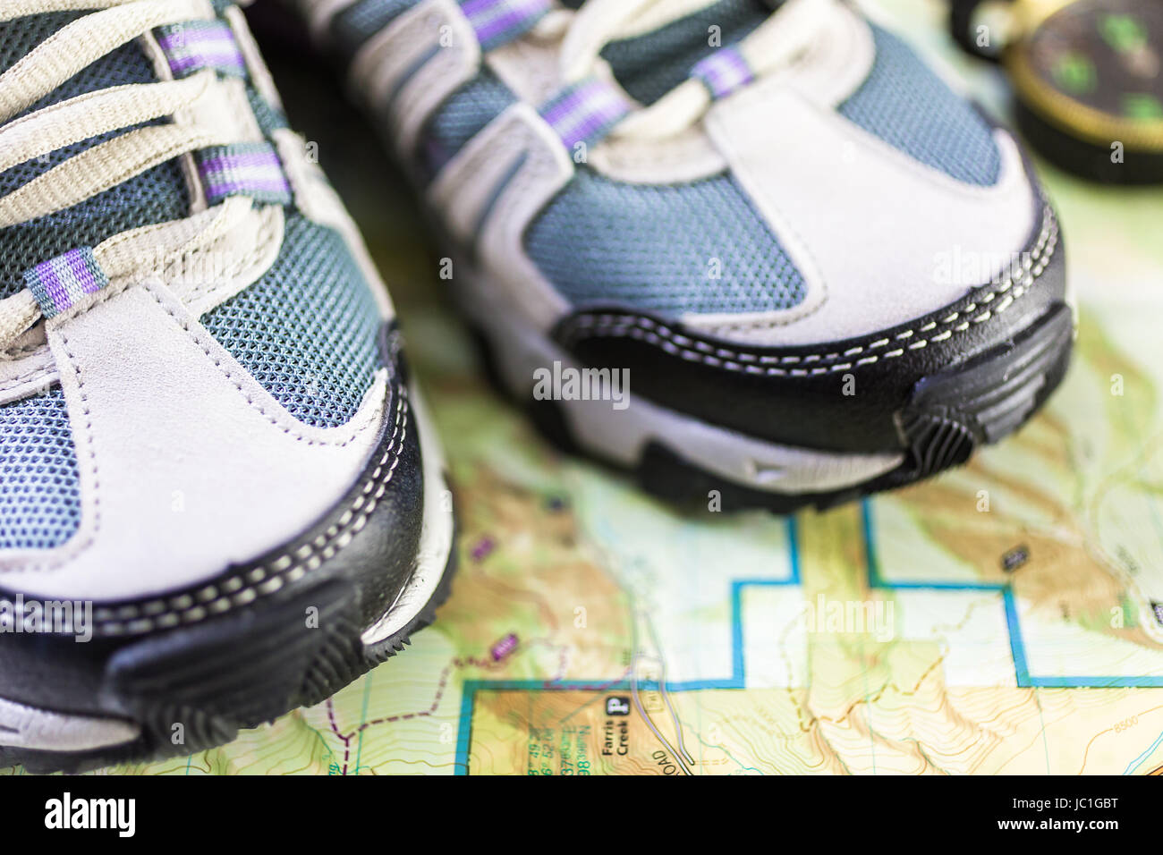 Pair of new womens hiking shoes with topo map on a white background ...