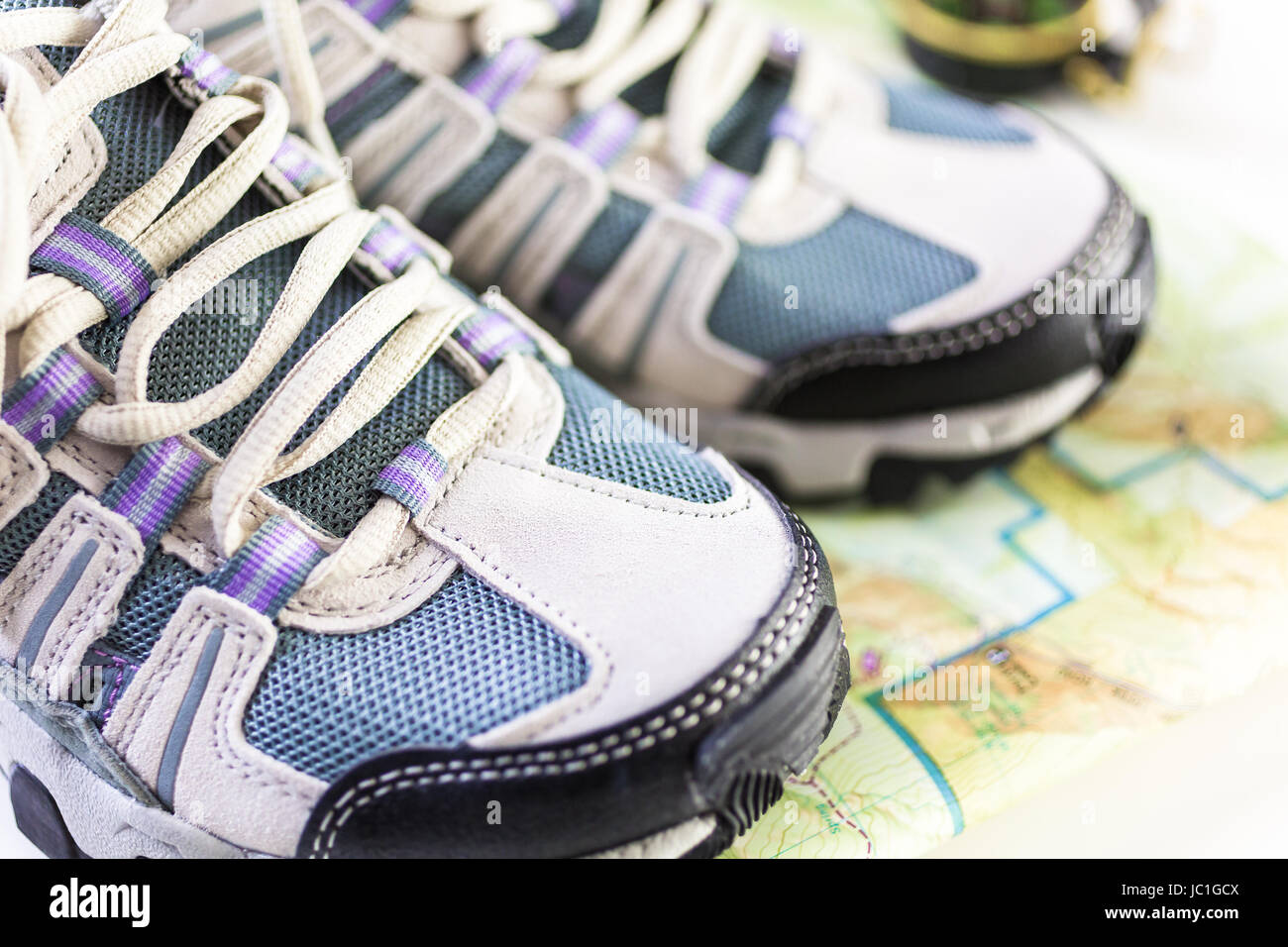 Pair of new womens hiking shoes with topo map on a white background ...