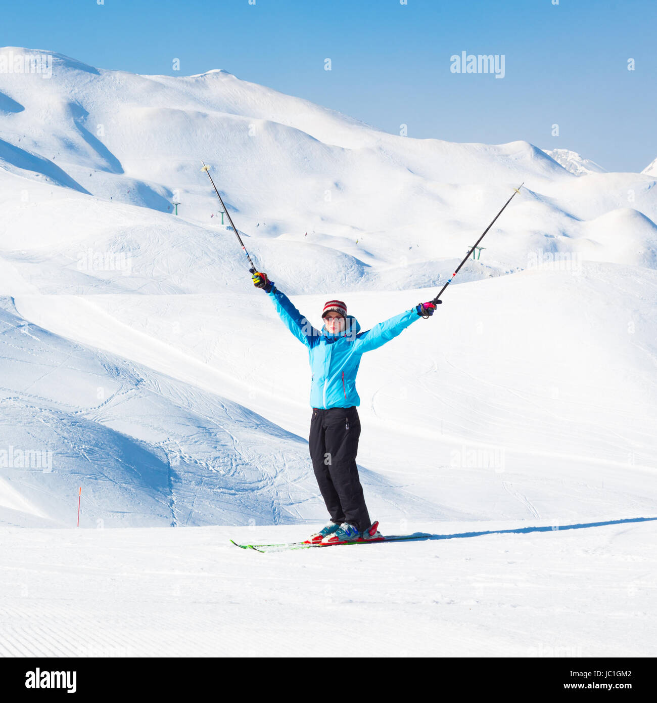 Excited woman skier, hands rised in the Alps Mountains, Triglav natural ...