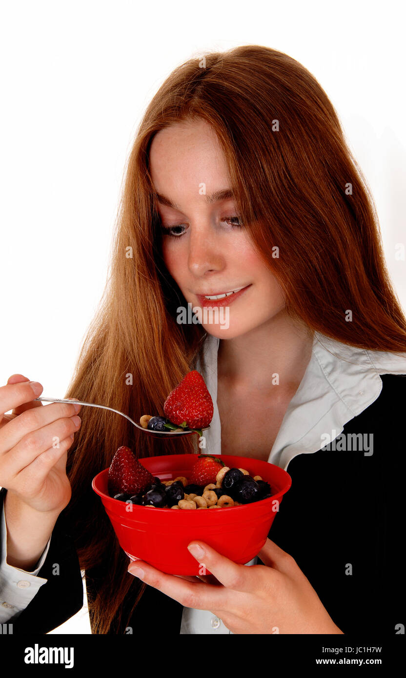 A closeup picture of a young woman holding a bowl with serial and ...
