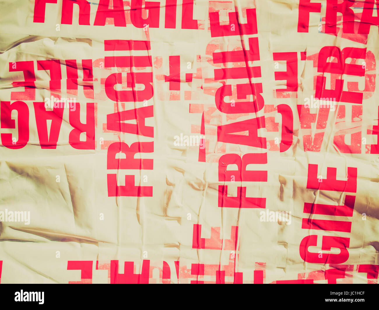 Vintage retro looking Fragile warning label on tape on a packet parcel ...