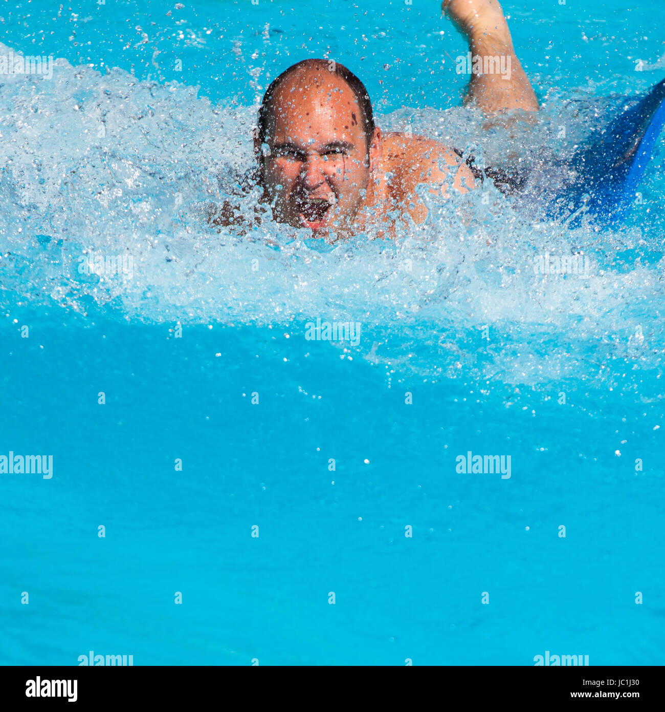 Man having fun, sliding at water park Stock Photo - Alamy