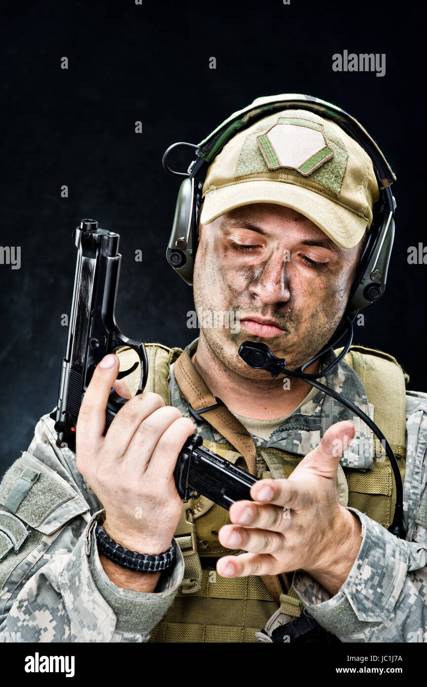 Soldier of USA army posing with a gun on a black background Stock Photo ...