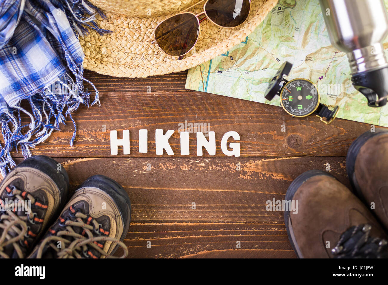 Hiking shoes with topo map and compass on a wood background Stock Photo ...