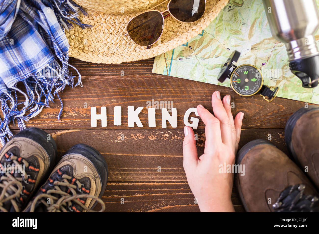 Hiking shoes with topo map and compass on a wood background Stock Photo ...